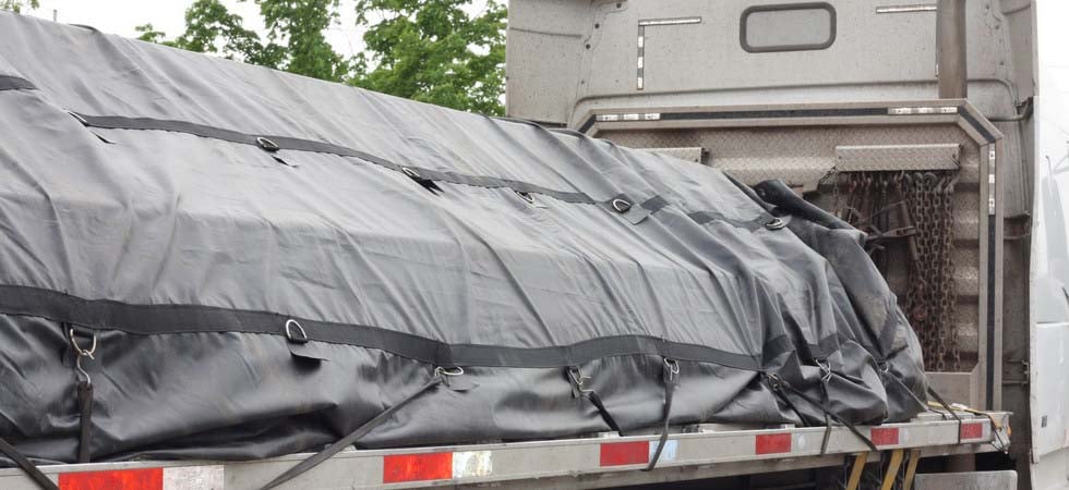Comparing a curtain side trailer to flatbed tarp systems